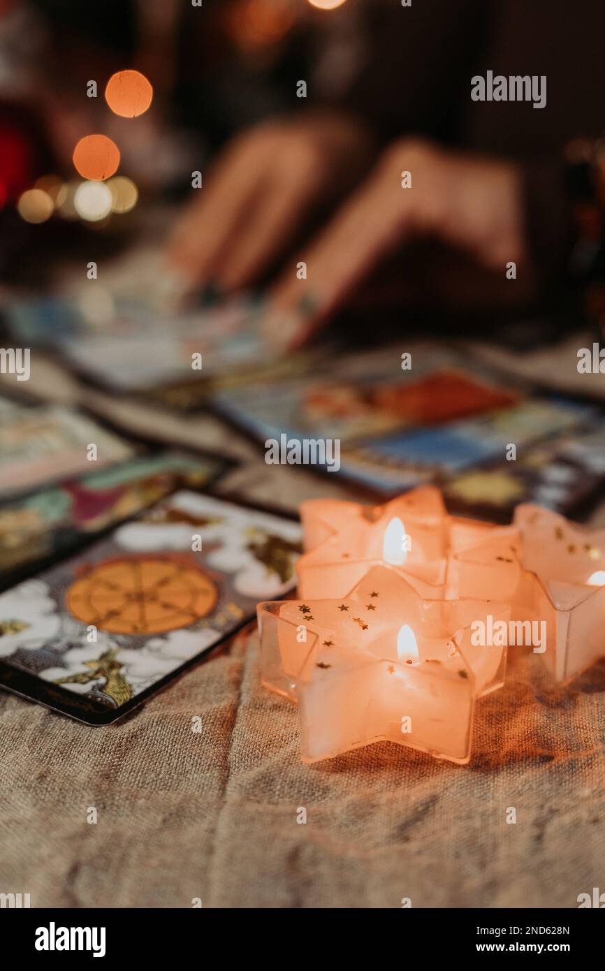 woman lays out magic cards on a table by candlelight. divination ...