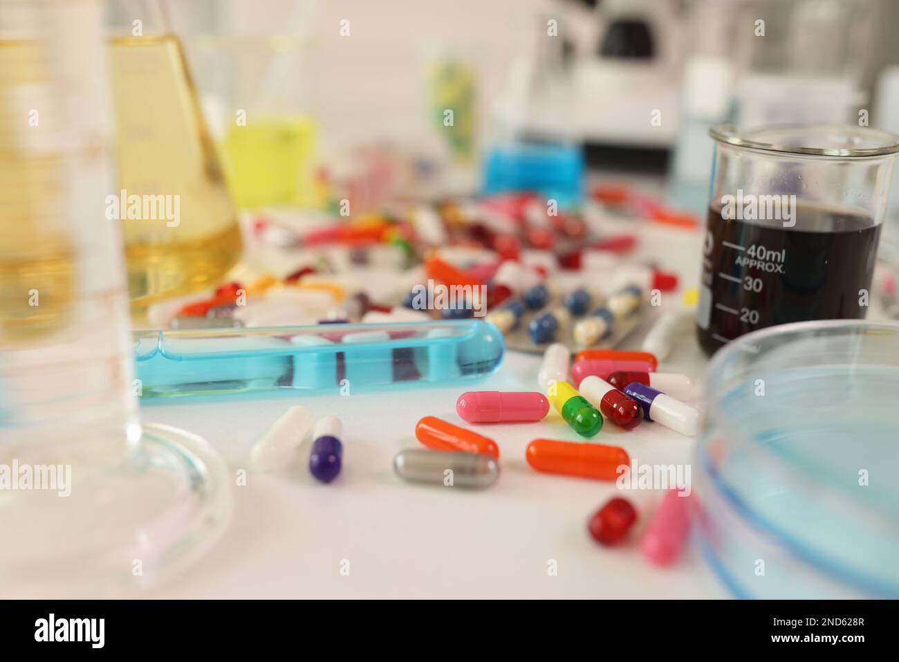 Colored capsules and test tubes on the table in laboratory Stock Photo ...