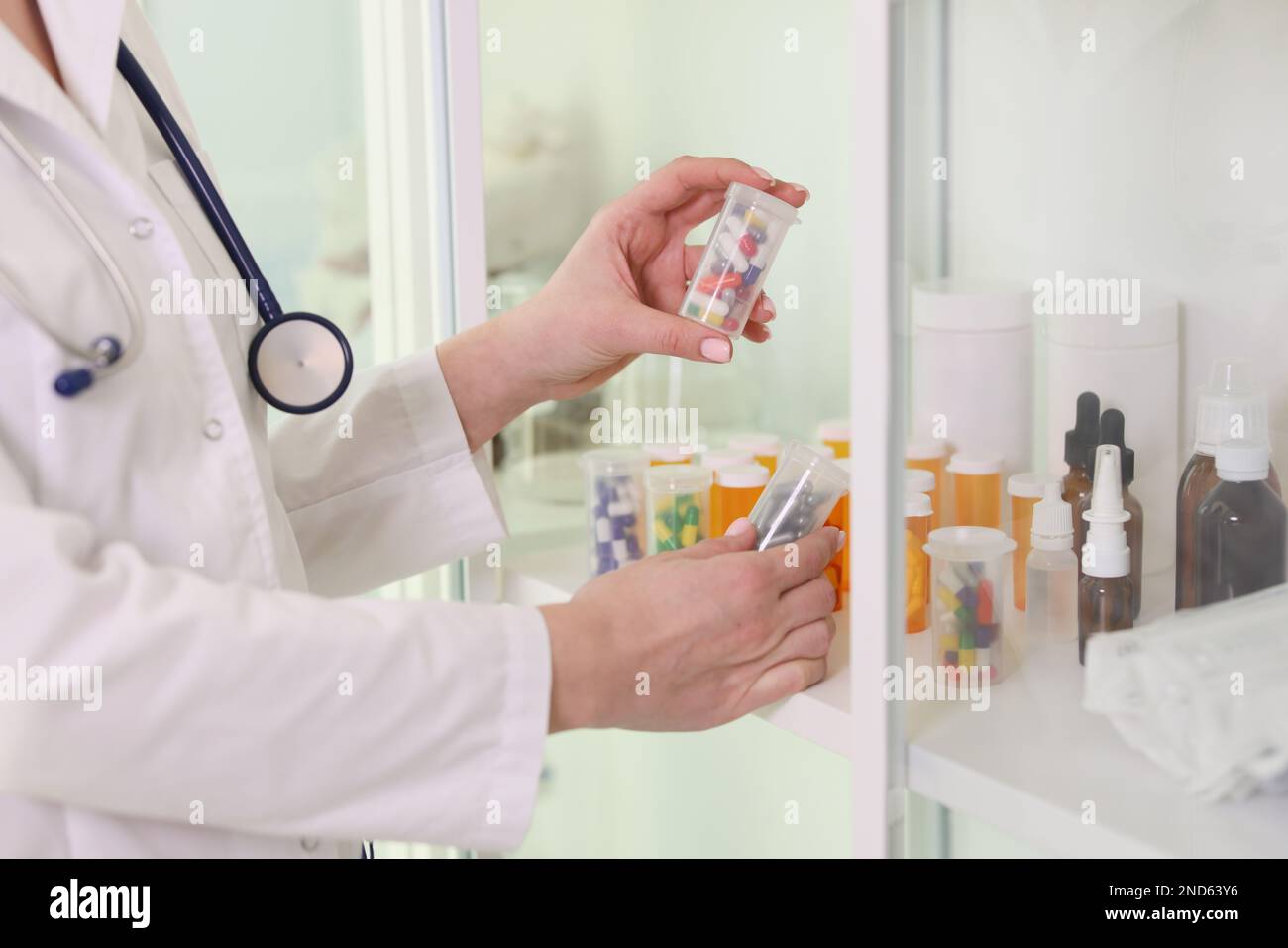 The pharmacist takes a capsule from the shelf, a close-up Stock Photo ...