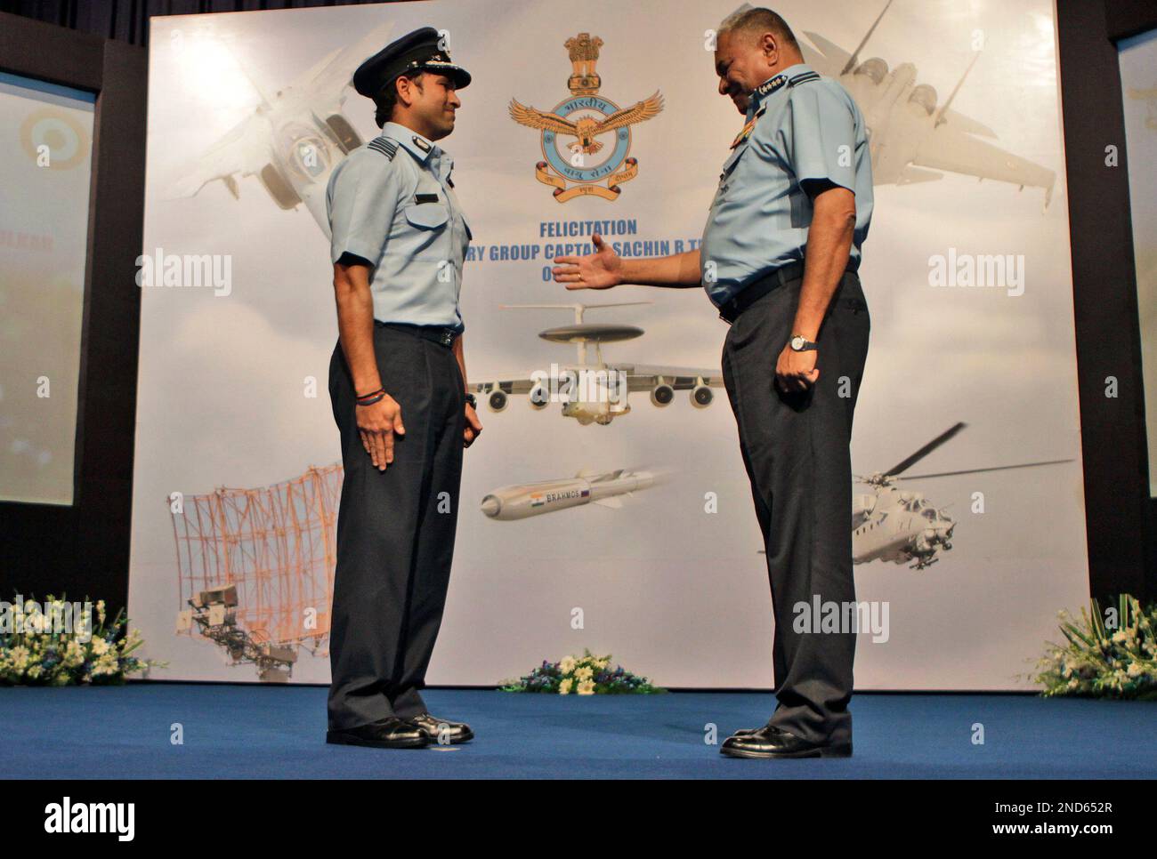 Indian cricket player Sachin Tendulkar, left, looks on after receiving ...