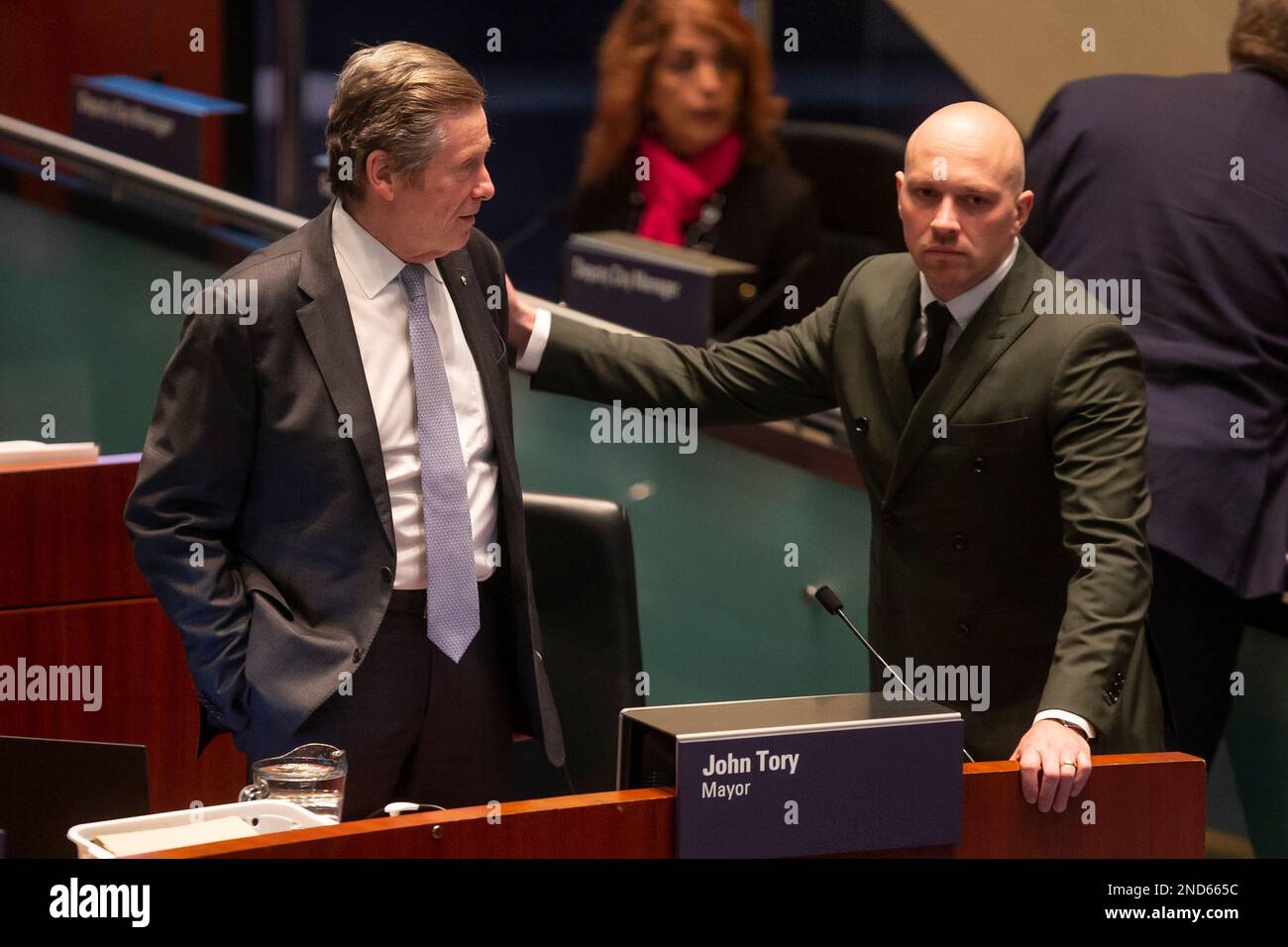 Mayor John Tory (left) talks to councillor Brad Bradford in the council ...