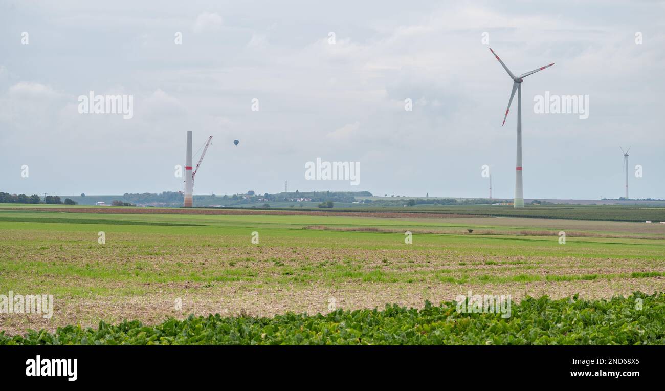 Modern renewable energy wind turbines next to wind turbine construction ...