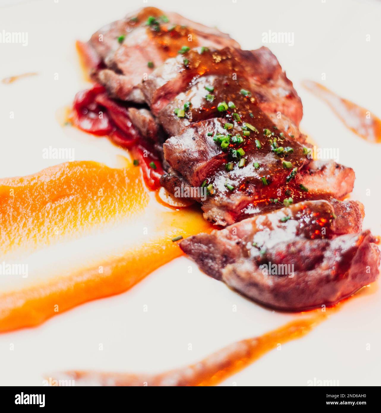 Very tender oven-roasted beef tenderloin with carrot sauce Stock Photo ...