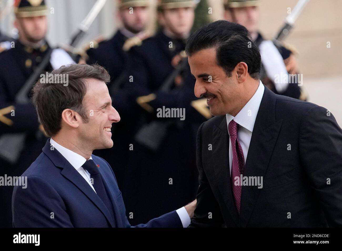 French President Emmanuel Macron, left, greets the Emir of Qatar Sheikh ...
