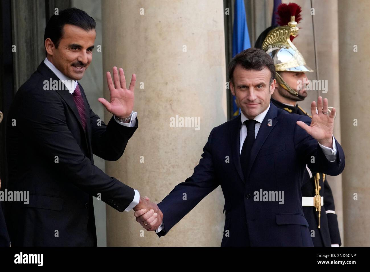 French President Emmanuel Macron, right, poses with the Emir of Qatar ...