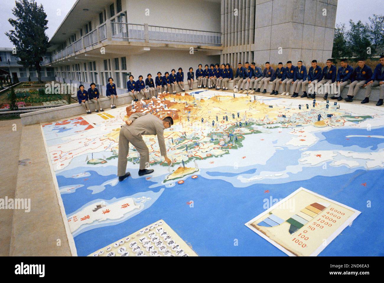 Students of Kinmen High School sit around large relief map of China ...