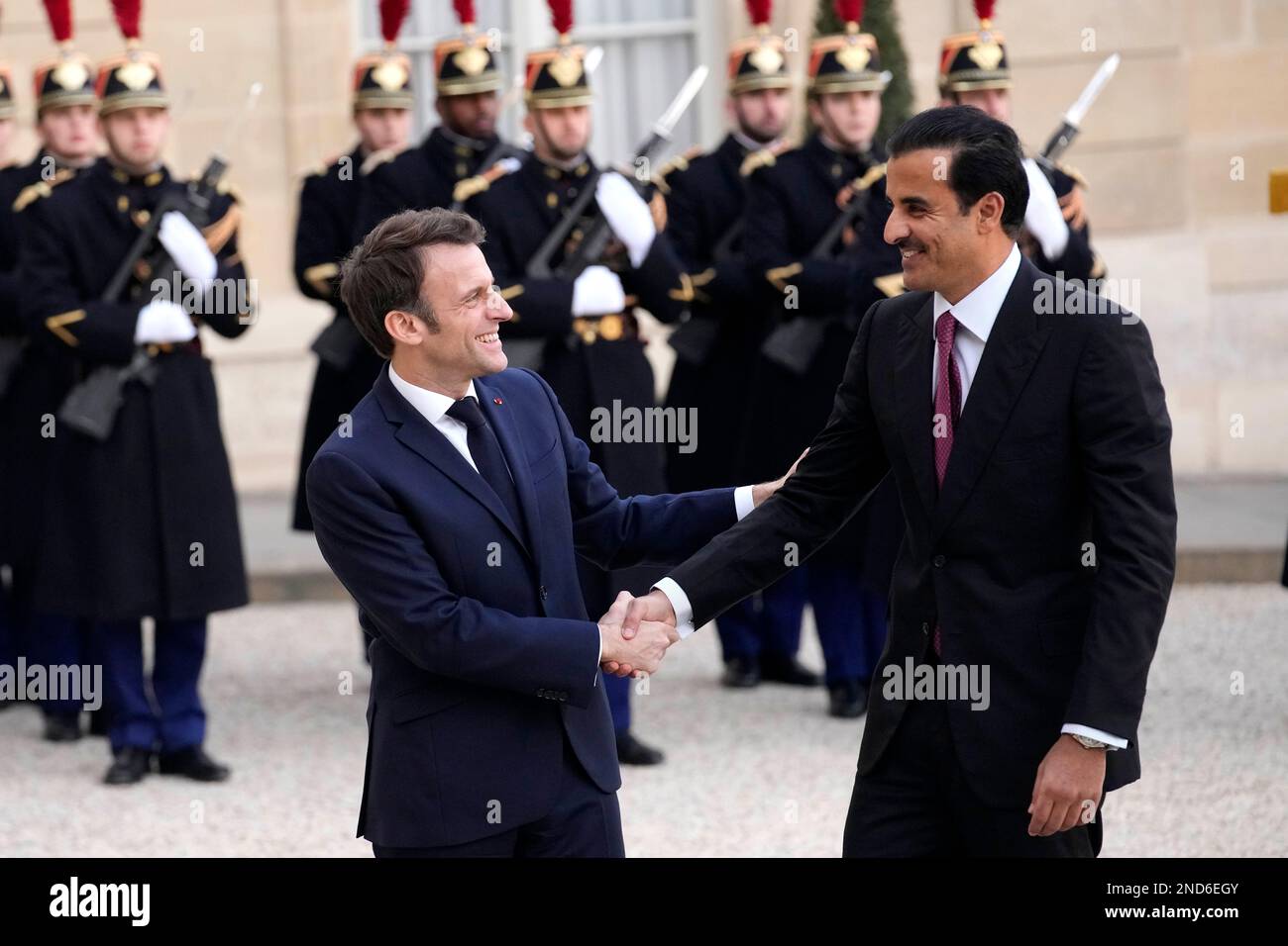 French President Emmanuel Macron, left, greets the Emir of Qatar Sheikh ...