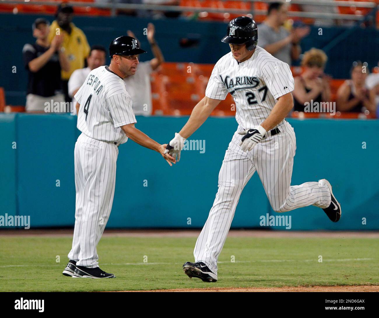 Florida Marlins' Mike Stanton (27) is congratulated by third base coach ...