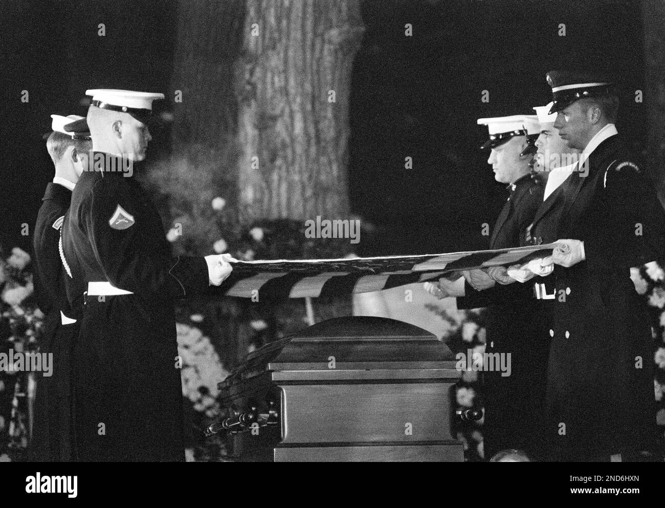 Honor Guard holds the American flag over the coffin of the late Sen ...