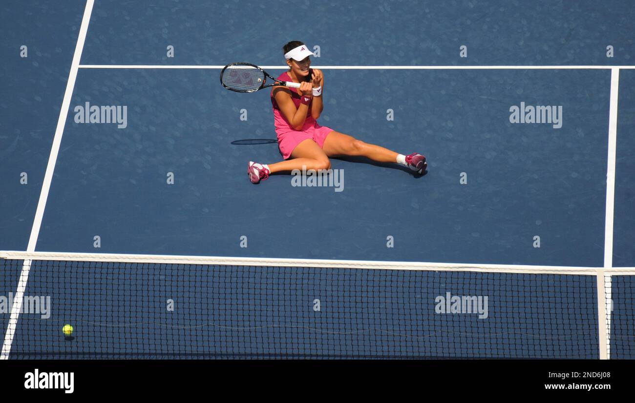 Ana Ivanovic of Serbia laughs as she sits on the court after taking a ...