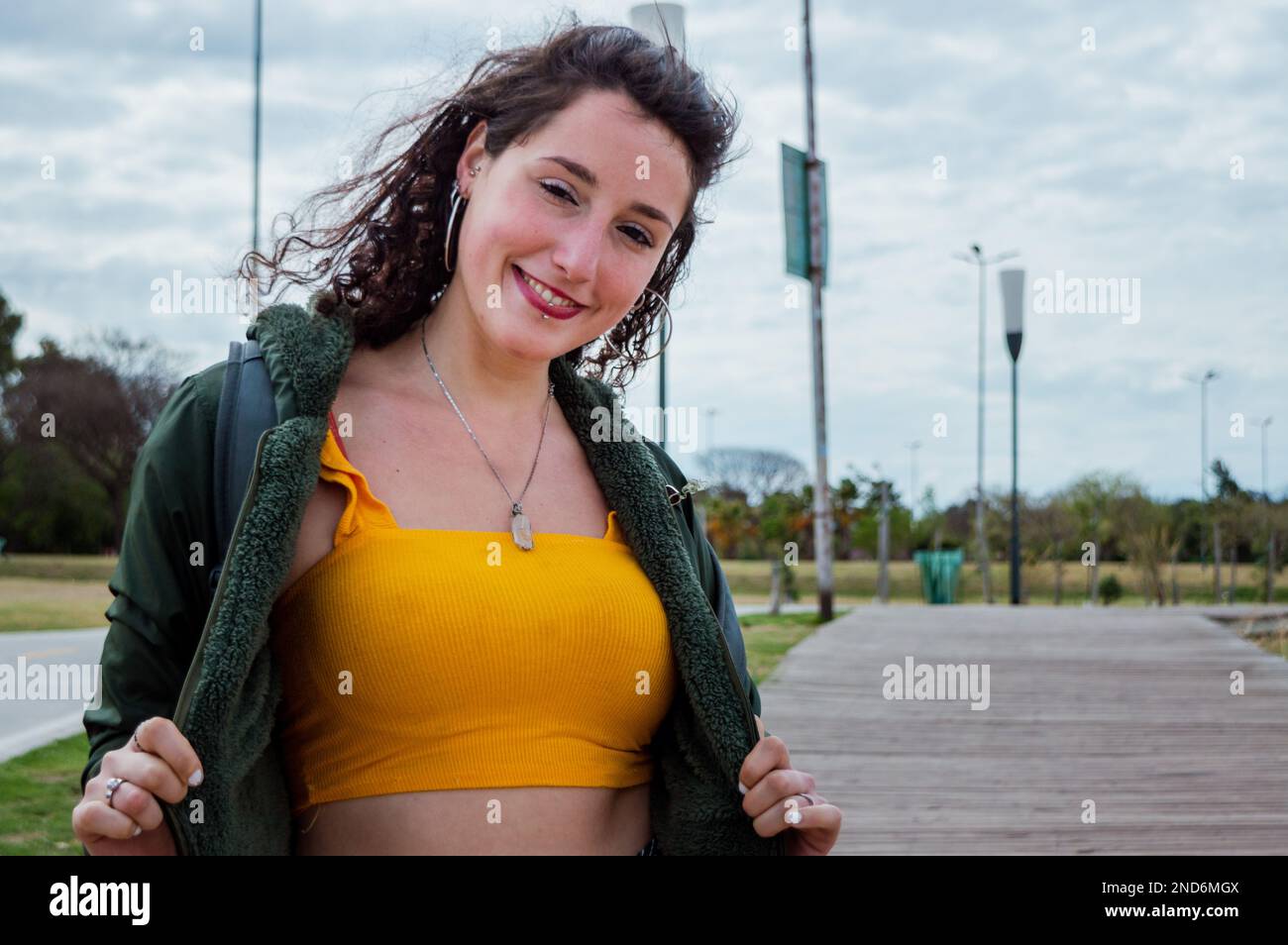 portrait of happy young latina woman of argentinian ethnicity, dressed ...