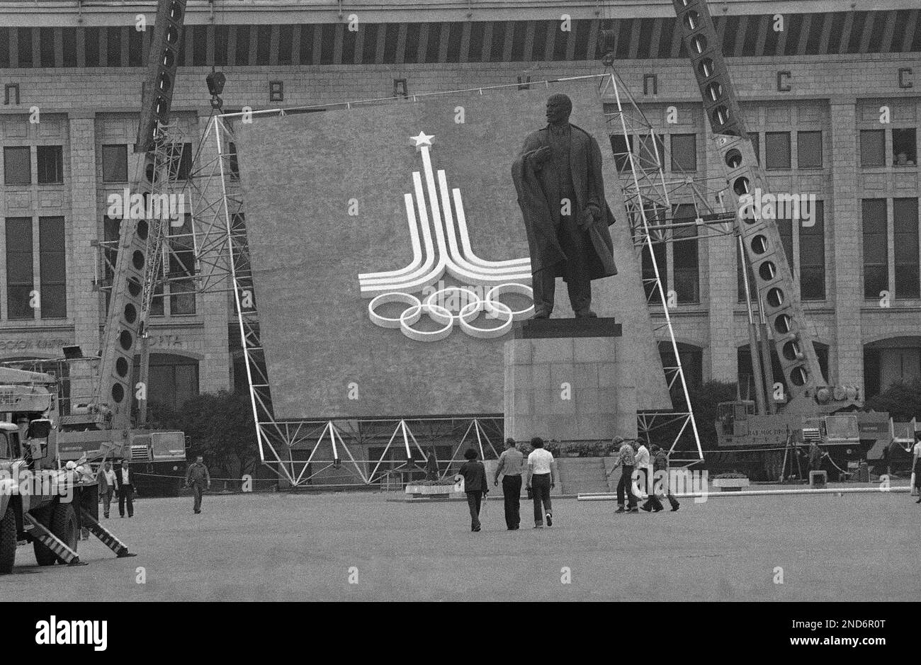 Workers get up a huge wall with the Moscow Olympic sign behind the ...