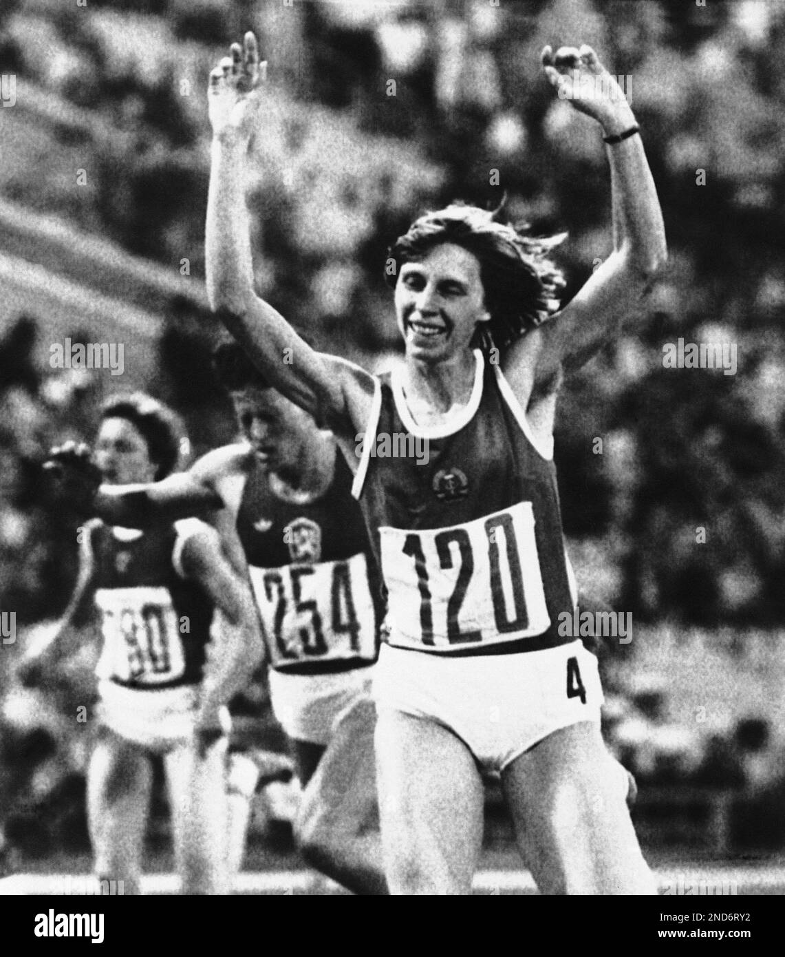East Germany’s Marita Koch raises victorious arms crossing finish line ...