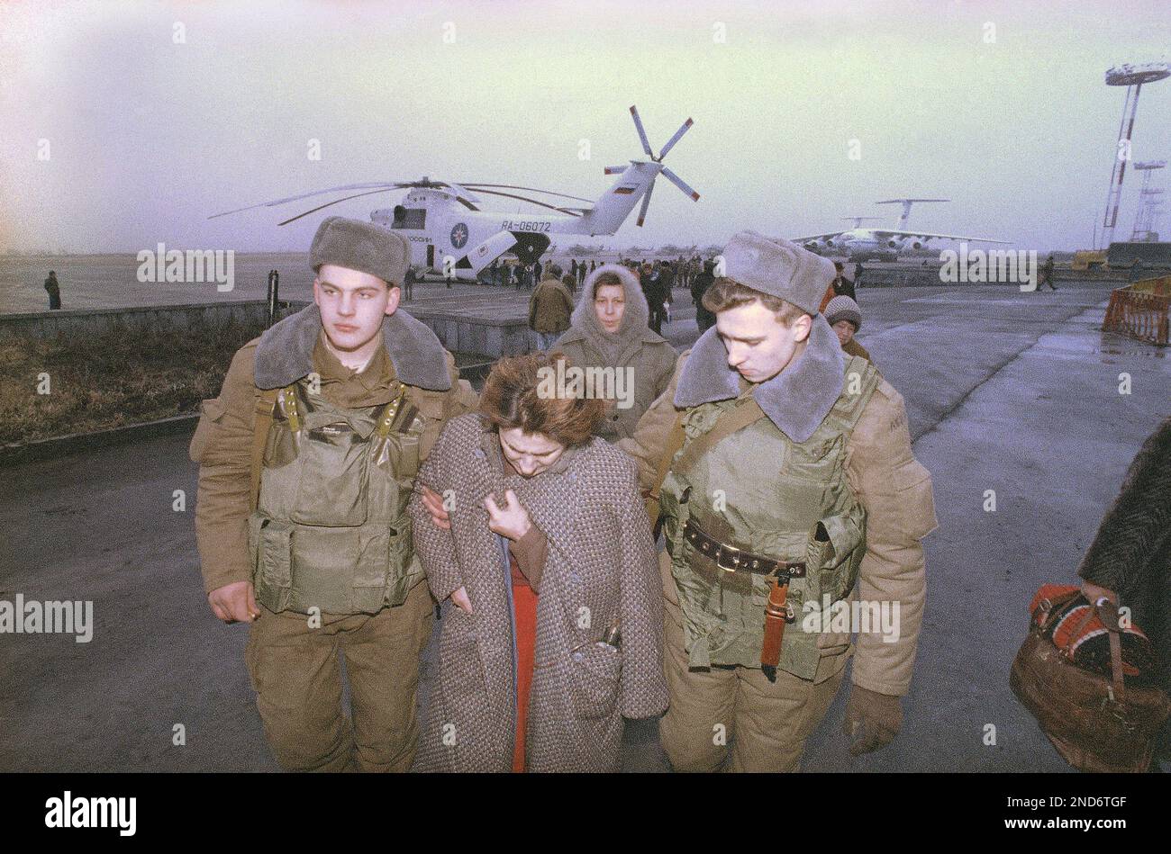 Two Russian soldiers help a wounded Chechen woman after she was ...