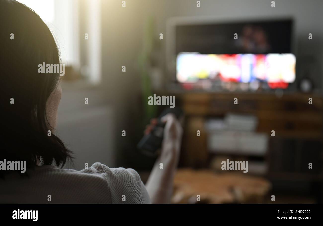 Woman watching television at home Stock Photo - Alamy