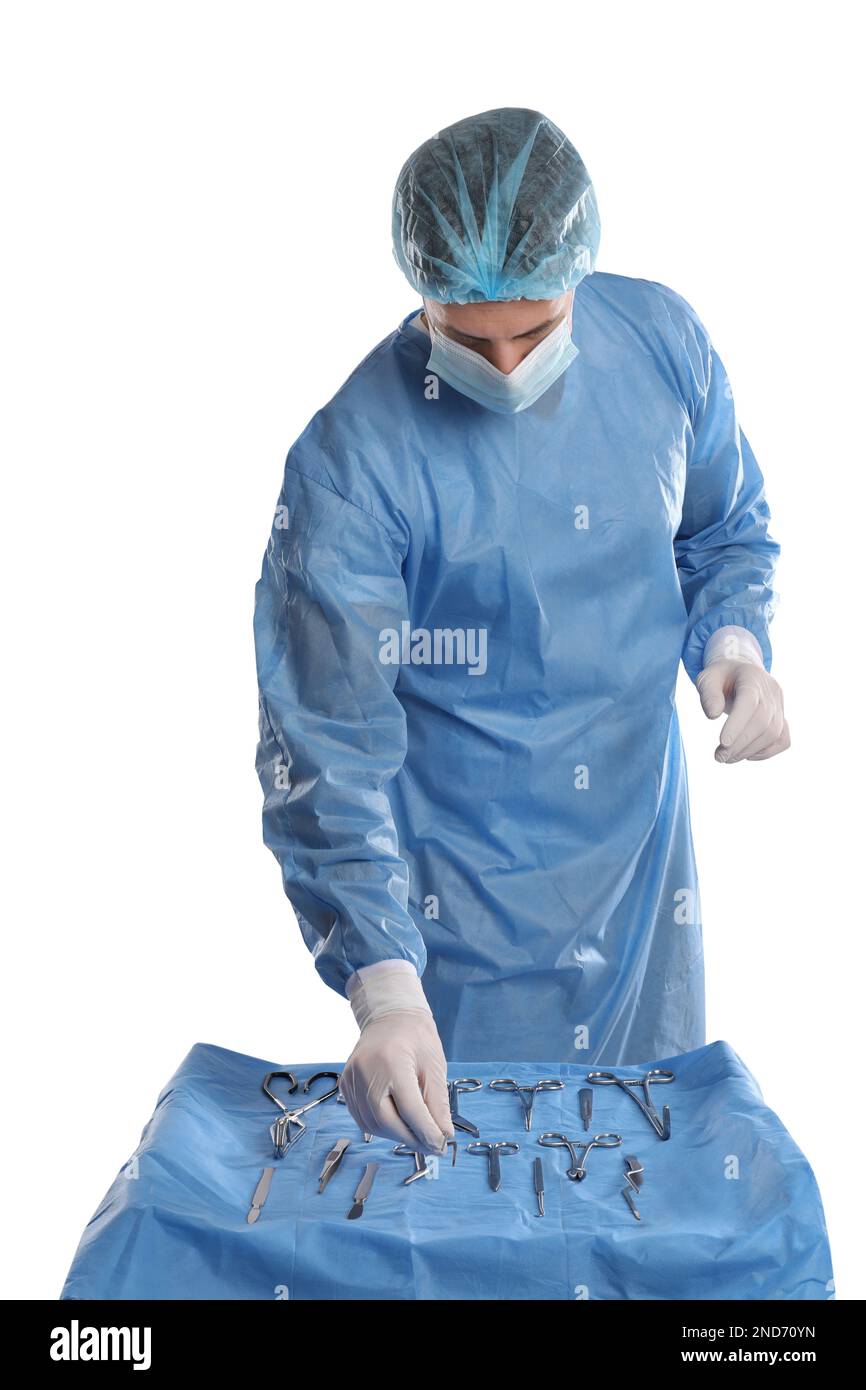Doctor taking surgical instrument from table on light background Stock ...