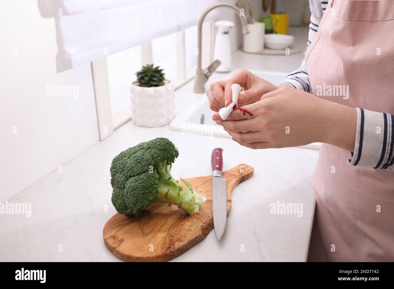 Woman cut finger while cooking in kitchen, closeup Stock Photo - Alamy