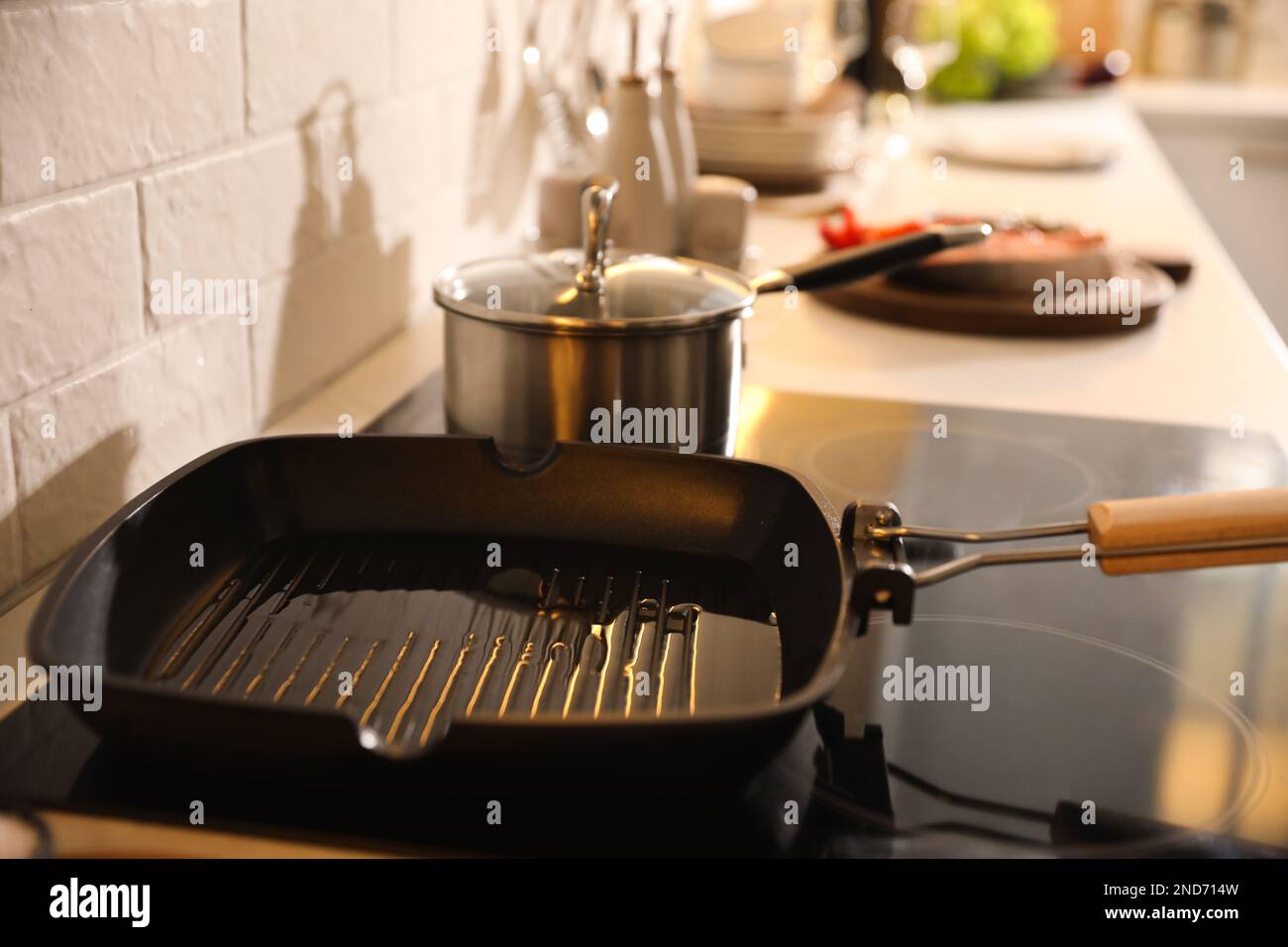 Frying pan with cooking oil on stove Stock Photo - Alamy