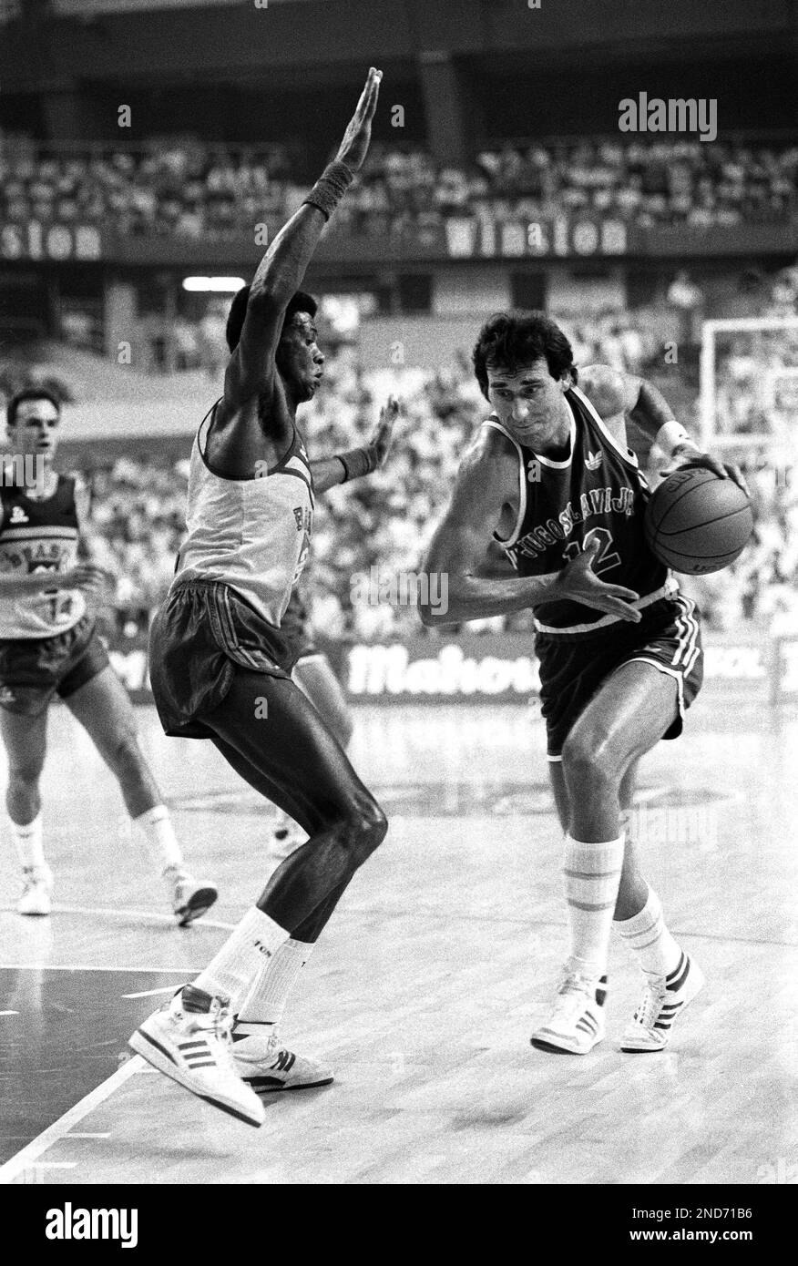 Yugoslav guard Drazen Petrovic (4) drives past Brazil's Rolando ...