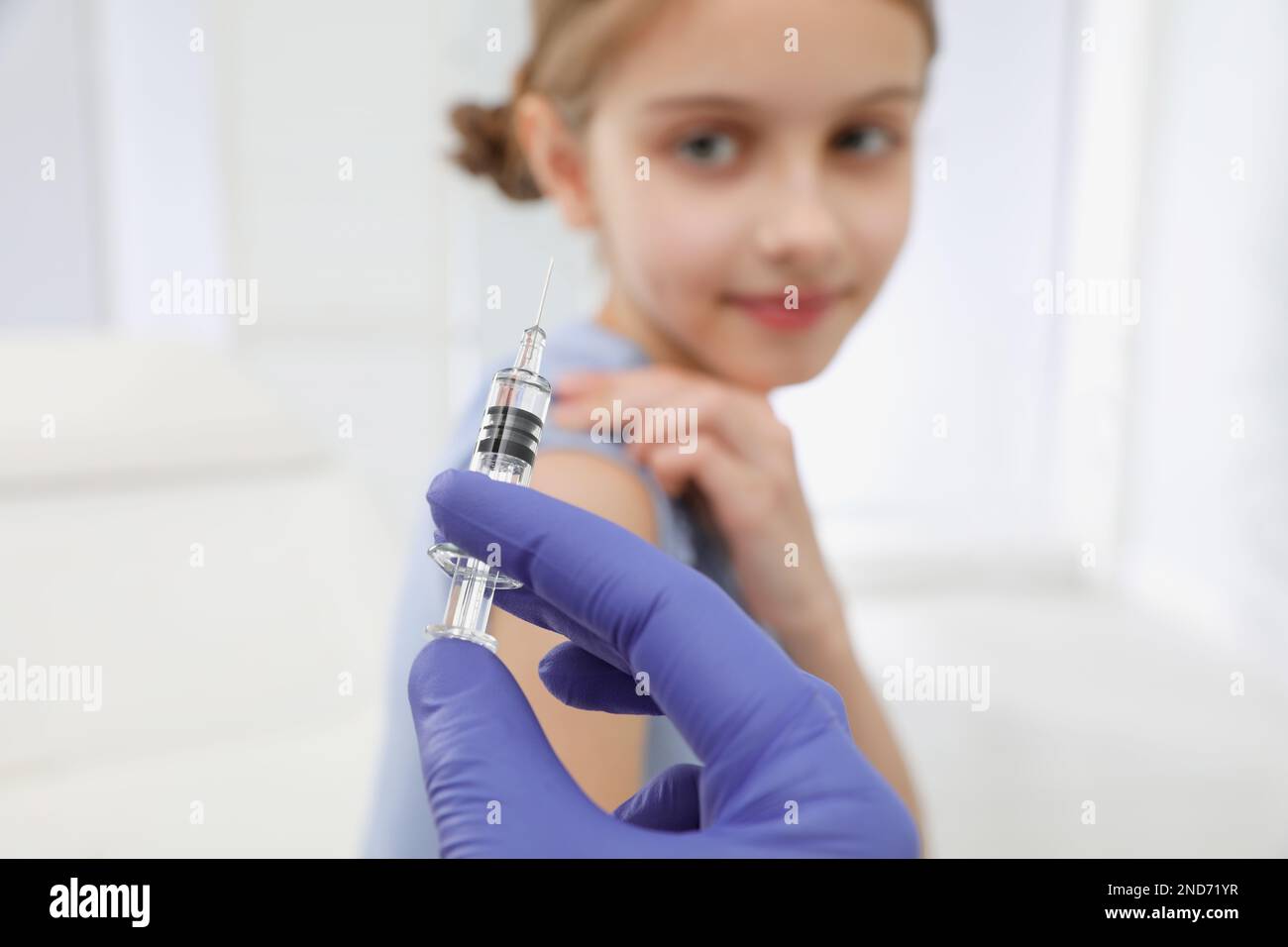 Doctor giving injection to little girl in hospital, focus on hand ...