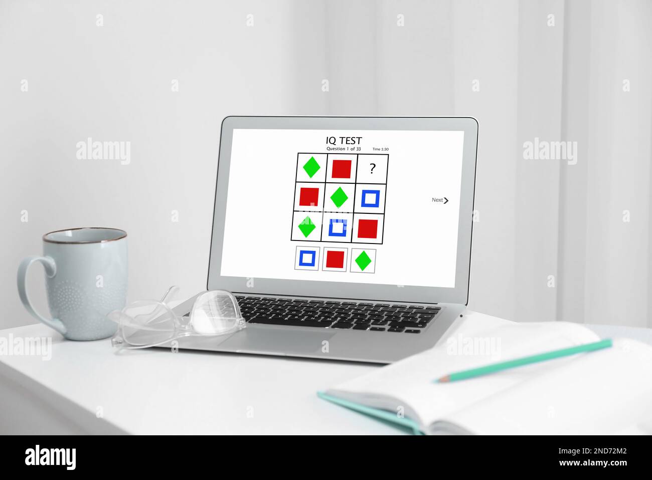 Modern laptop with IQ test on screen in office Stock Photo - Alamy