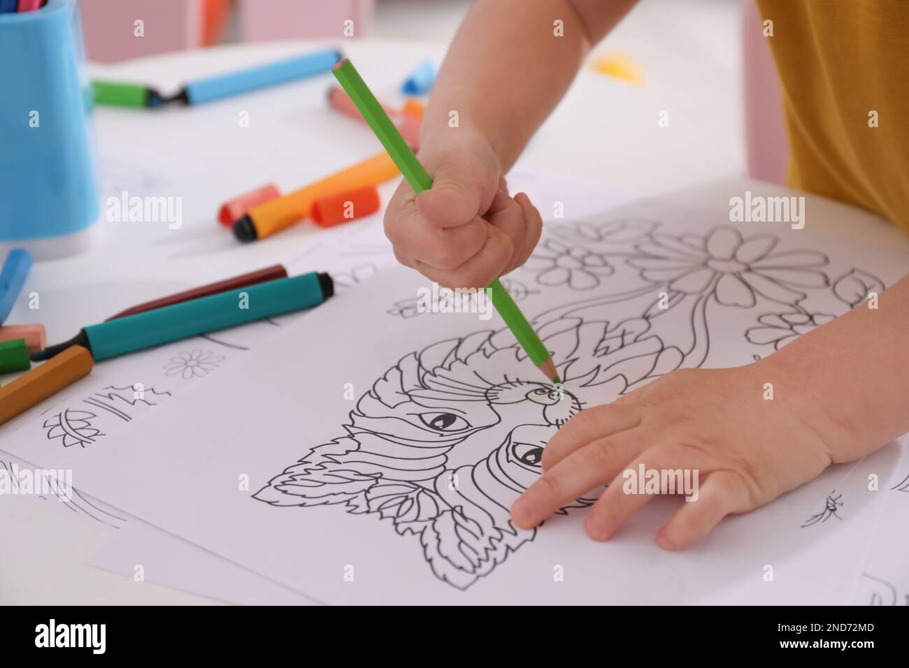 Child coloring drawing at table in room, closeup Stock Photo - Alamy