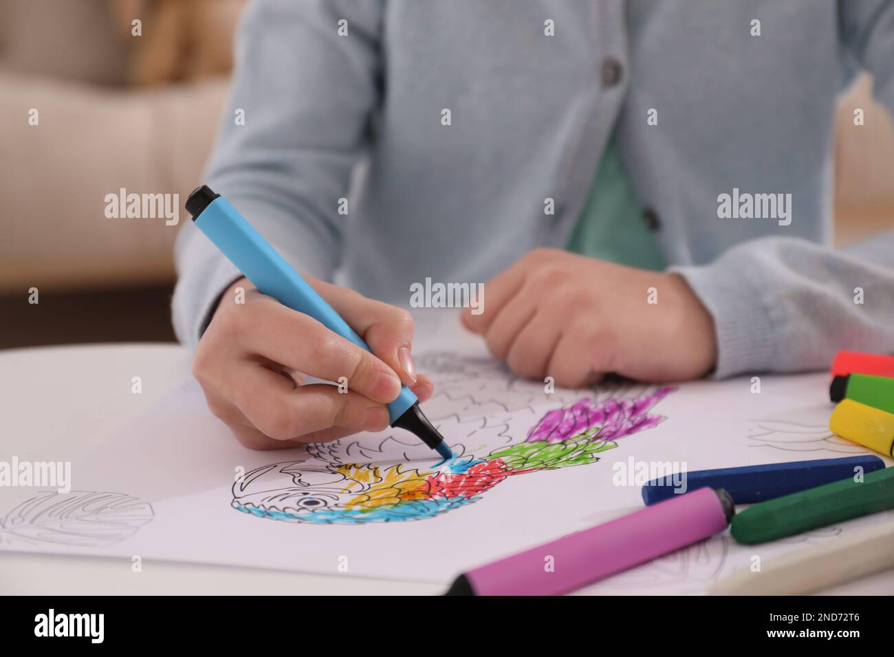 Child coloring drawing at table in room, closeup Stock Photo - Alamy