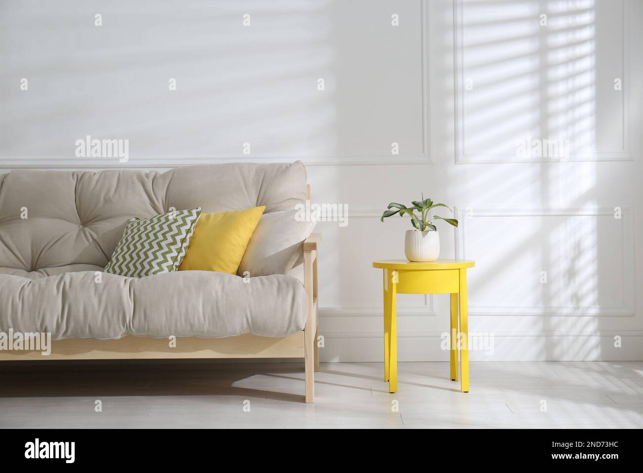 Stylish beige sofa in living room interior Stock Photo - Alamy