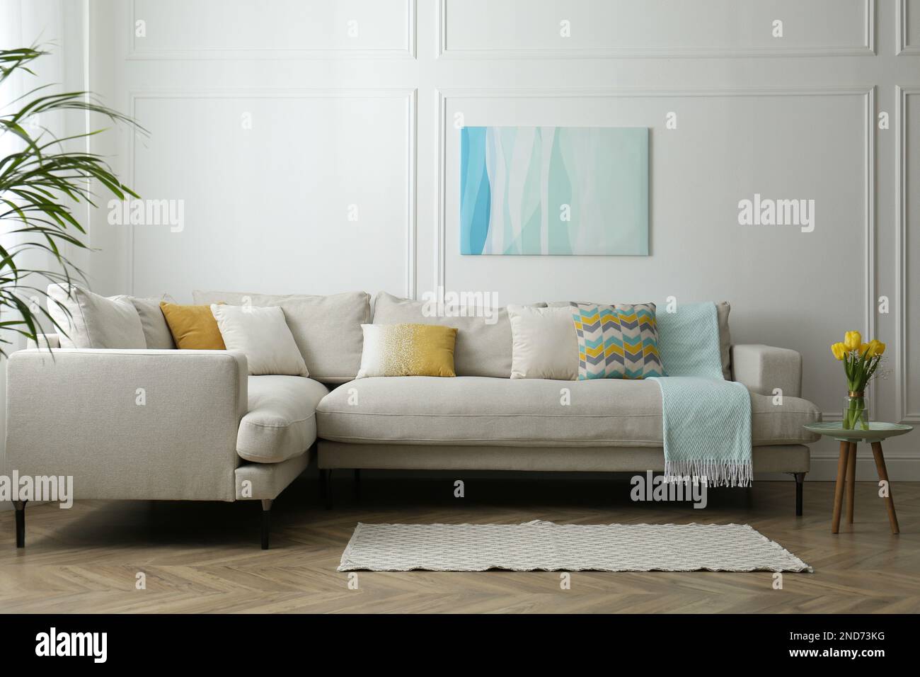 Stylish beige sofa in living room interior Stock Photo - Alamy