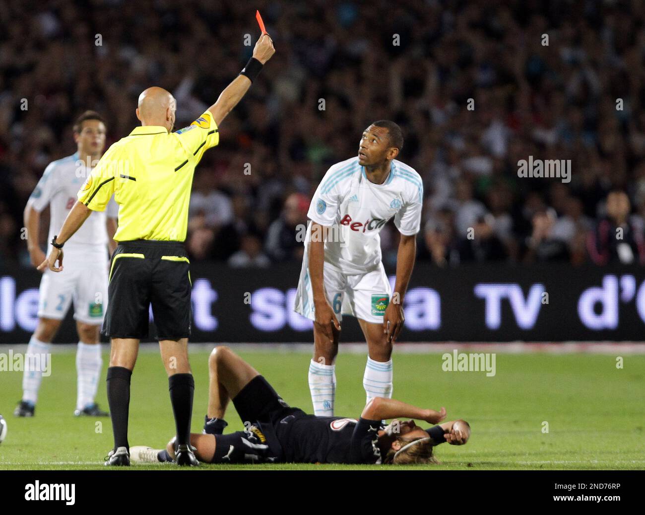 Referre Tony Chapron gives Marseille' s Edouard Cisse a red card during ...