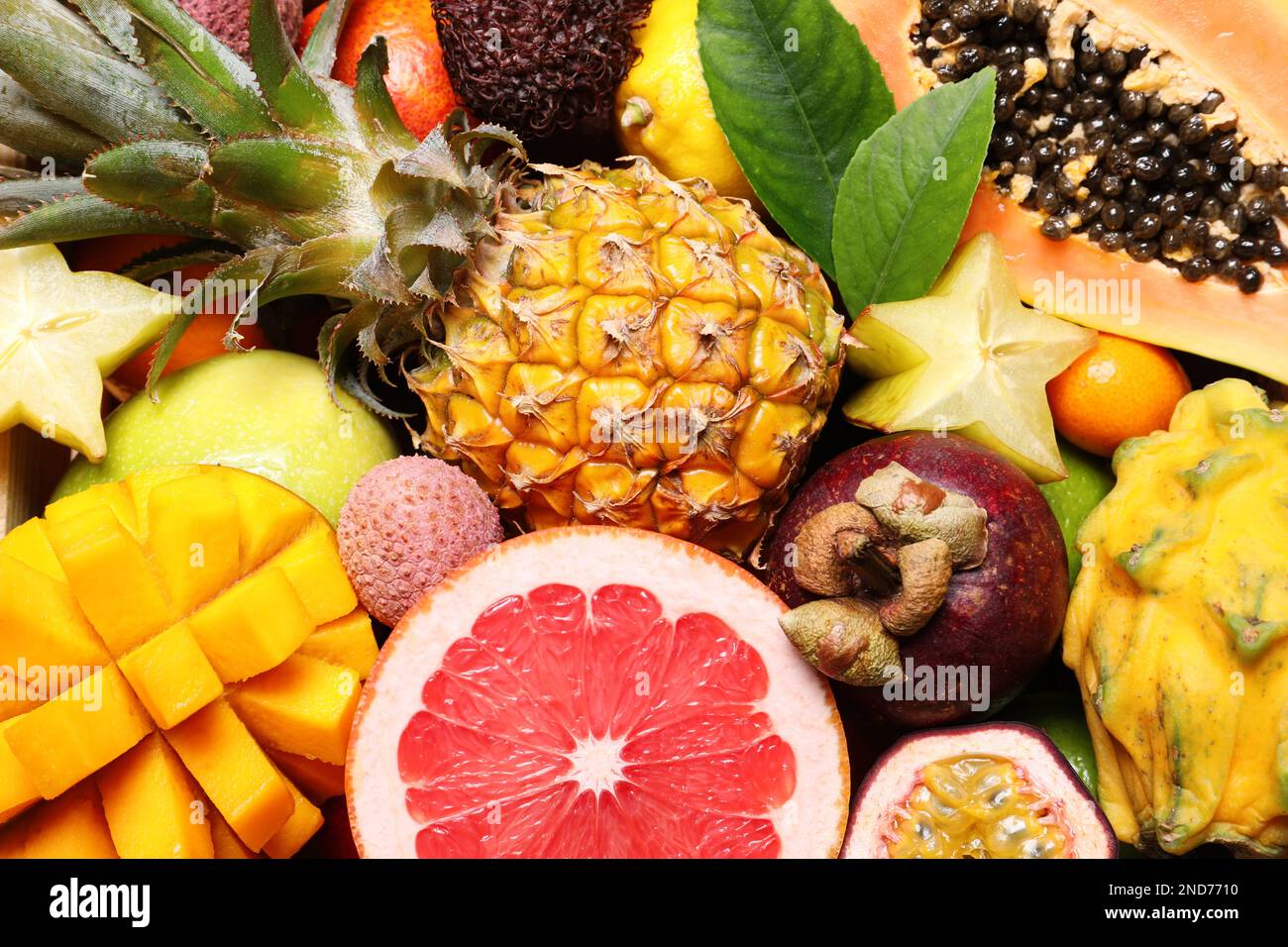 Different delicious exotic fruits as background, top view Stock Photo ...