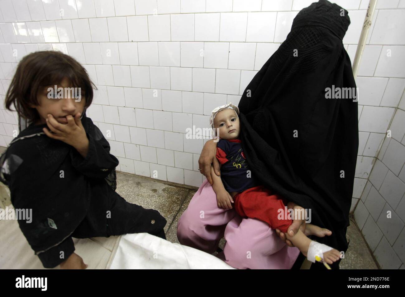 In this photo taken on Aug 27, 2010, A mother who survived floods with ...