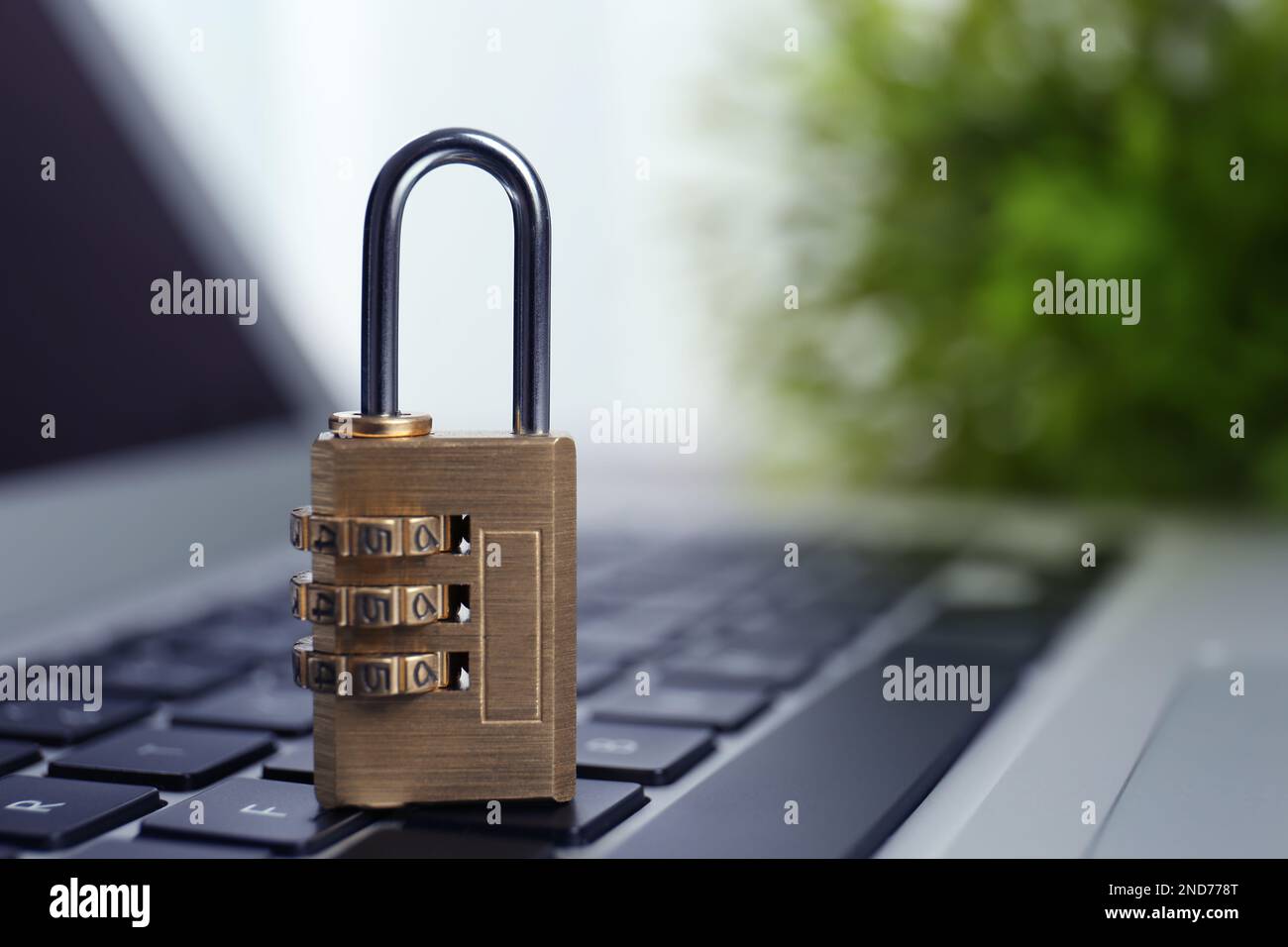 Metal code padlock on laptop keyboard, space for text. Cyber security ...