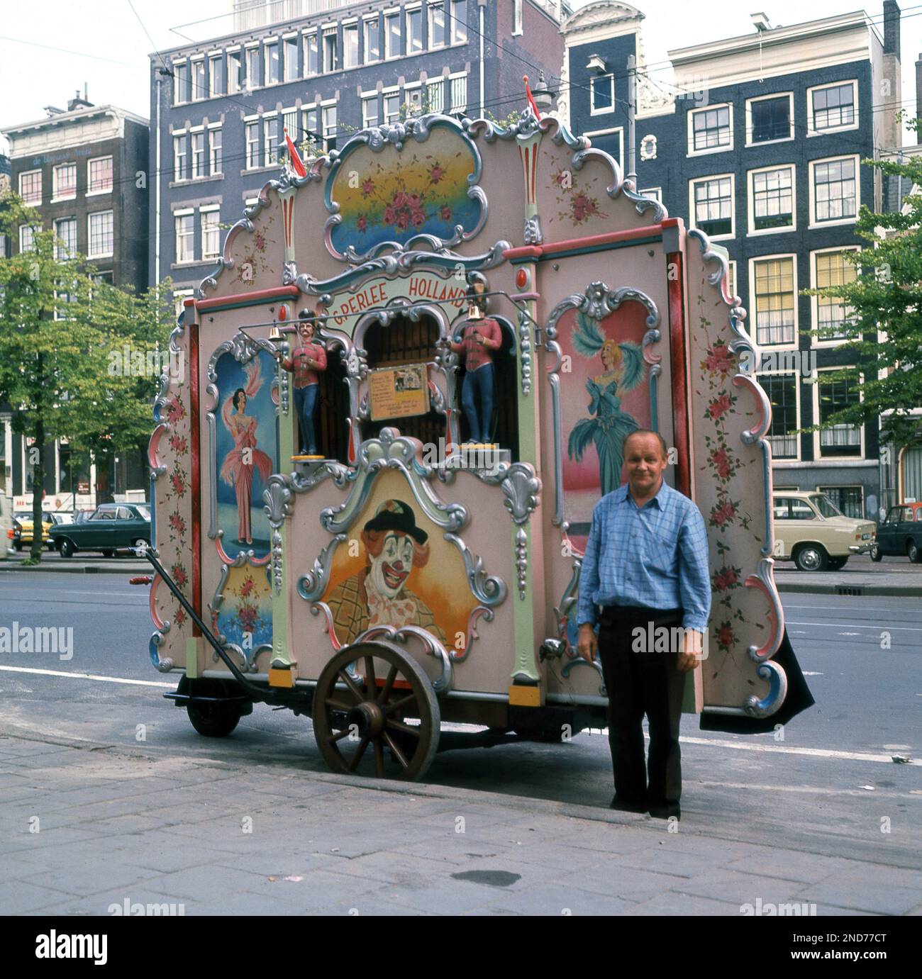 Late 1960s, historical, a man standing by a traditional street organ ...