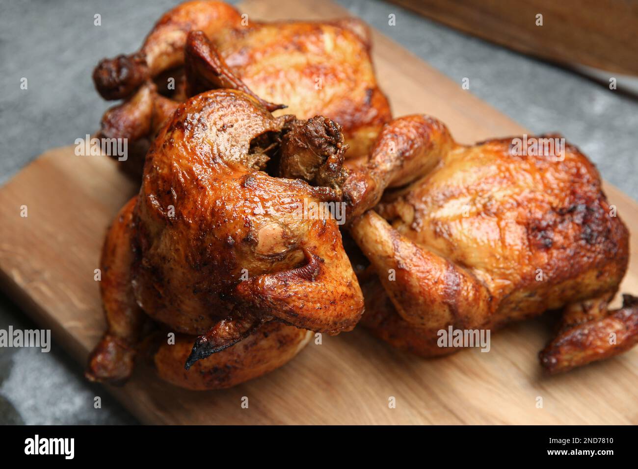 Delicious grilled whole chickens on grey table, closeup Stock Photo - Alamy