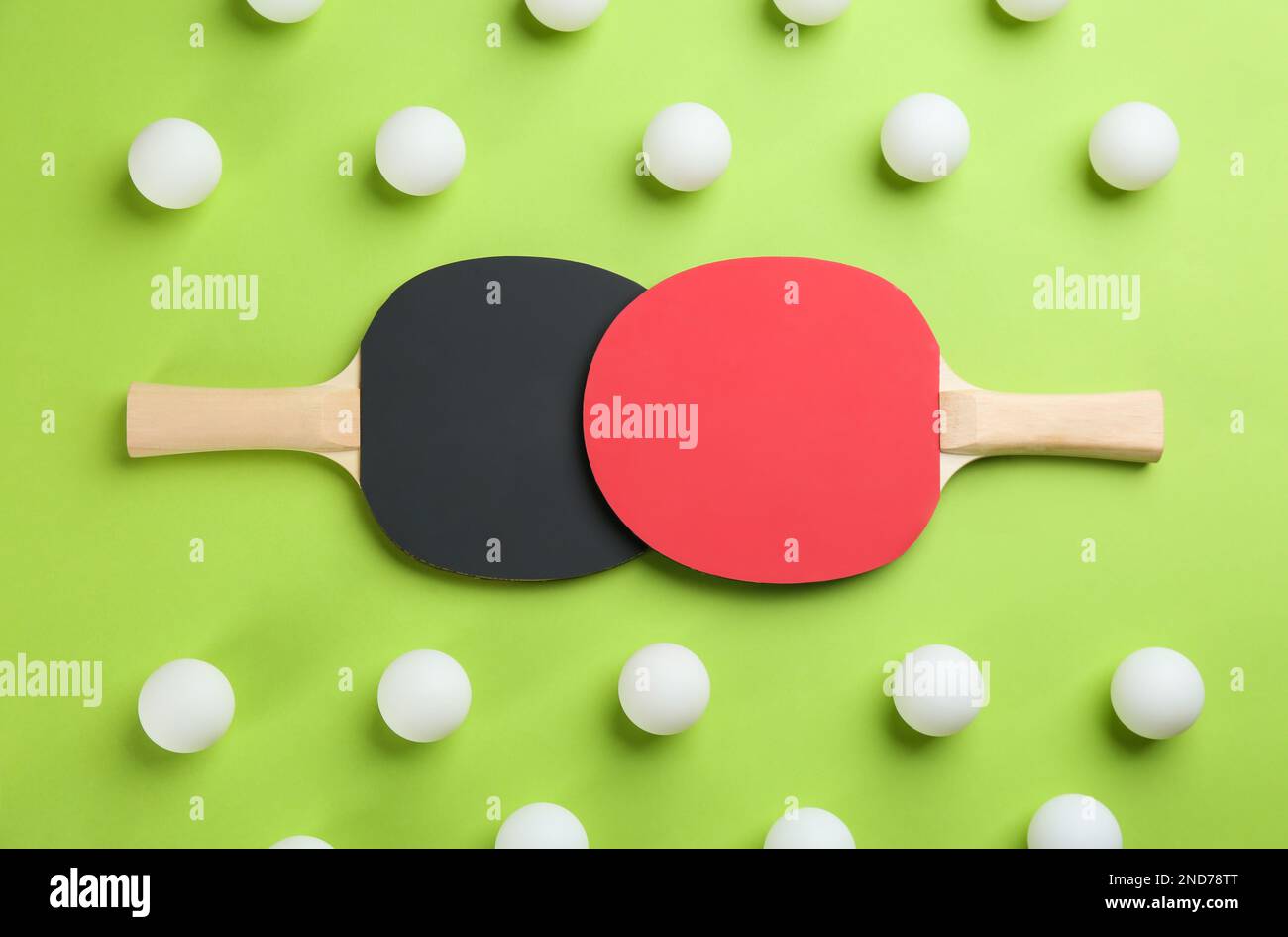 Ping pong rackets and balls on green background, flat lay Stock Photo ...