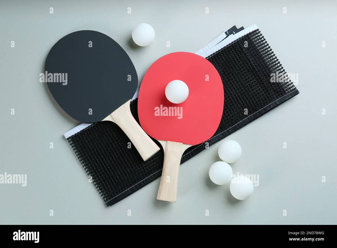 Ping pong rackets, net and balls on grey background, flat lay Stock ...