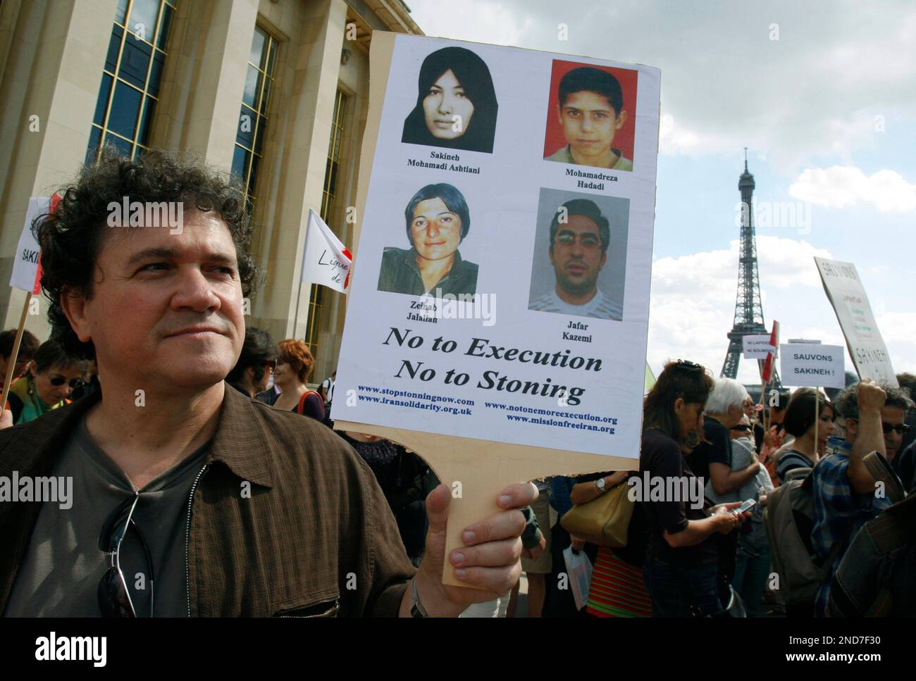 A demonstrator holds a placard to support Sakineh Mohammadi Ashtiani ...