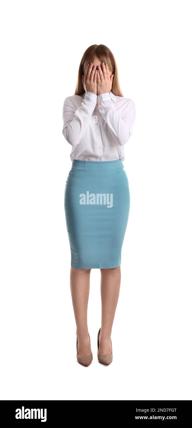 Upset woman closing her face with hands on white background Stock Photo ...