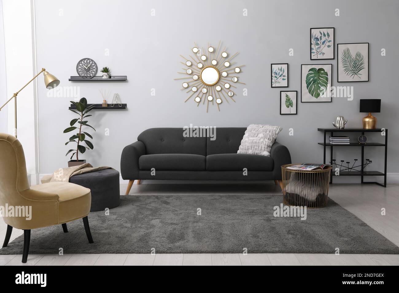 Stylish living room interior with comfortable sofa and floral pictures ...