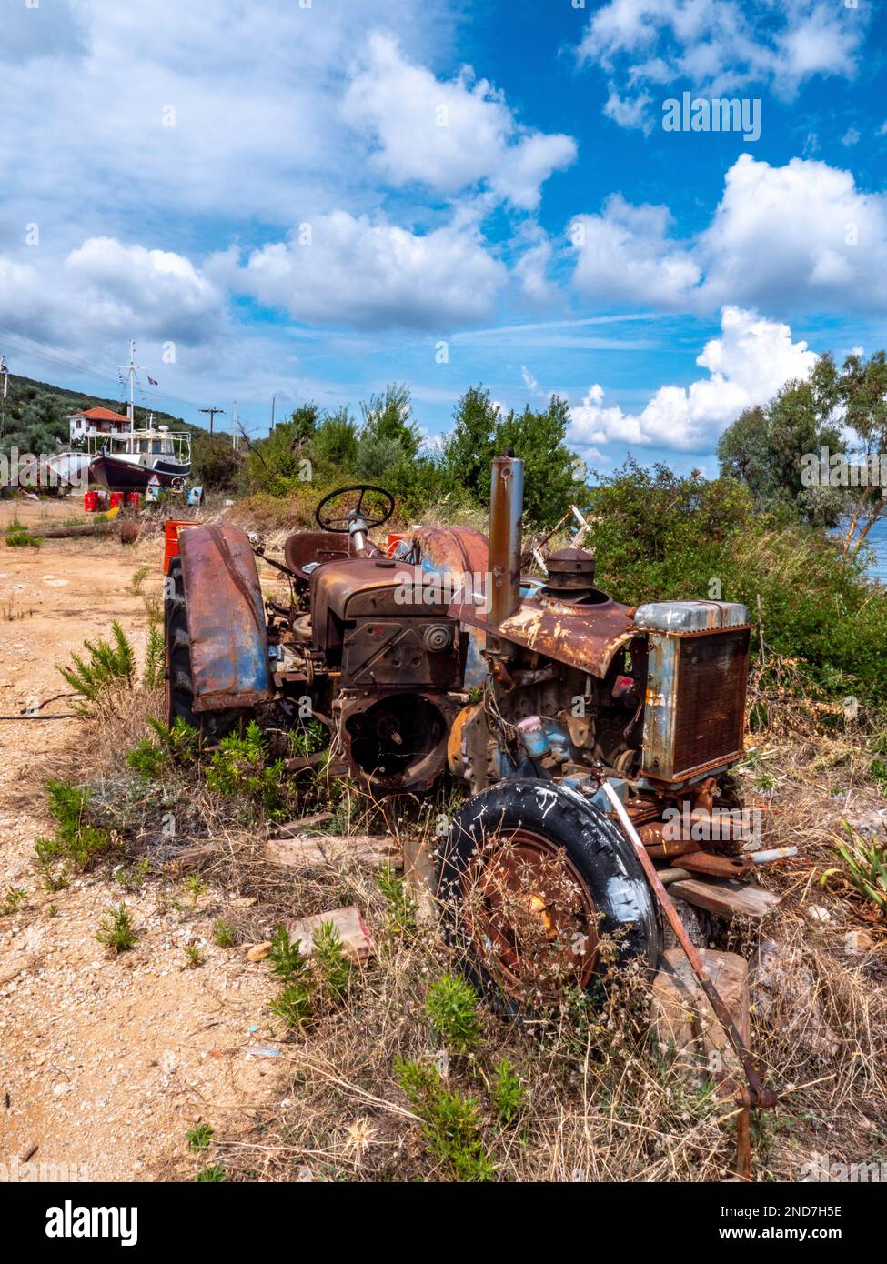 The rusty remains of an agricultural machine outdoors Stock Photo - Alamy