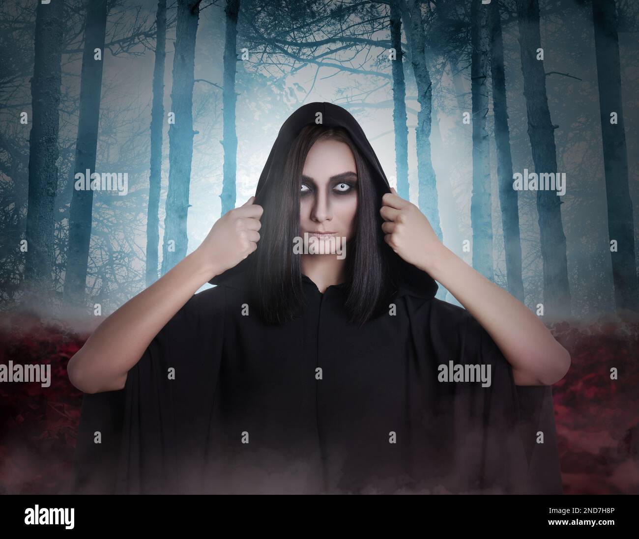 Witch wearing black mantle in foggy forest. Scary fantasy character ...