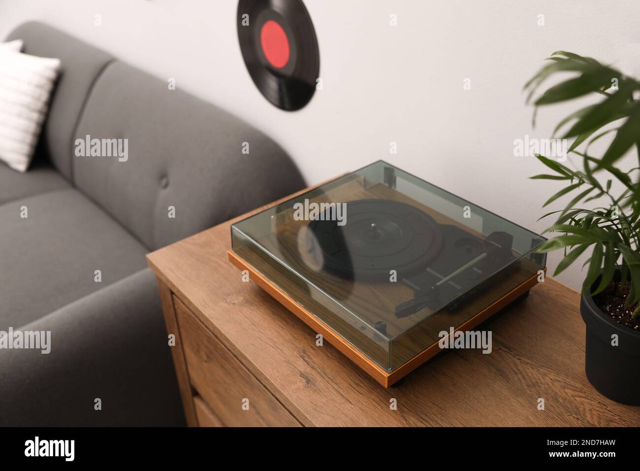 Stylish turntable on chest of drawers in living room Stock Photo - Alamy