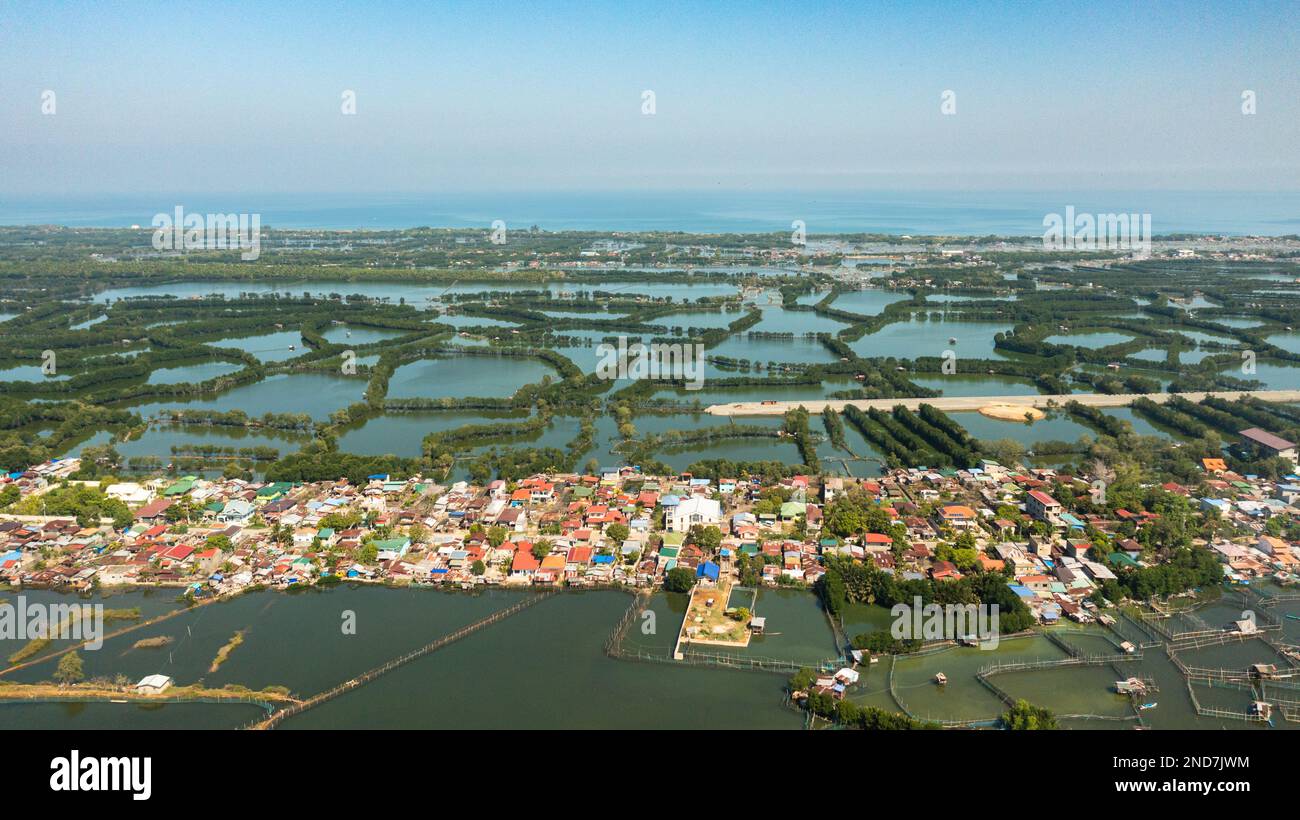 Aquaculture farm and village in the countryside of the Philippines ...