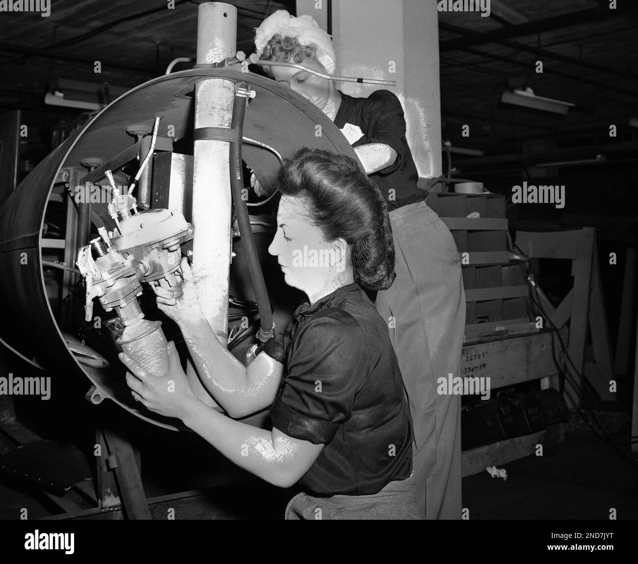 Installing fuel meter in aft fuselage section at Willys Overland Plant ...