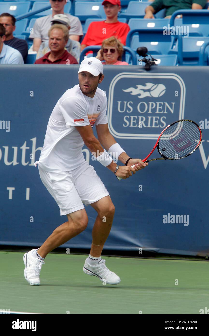 Mardy Fish, from Tampa, Fla., returns a serve against Andy Roddick ...