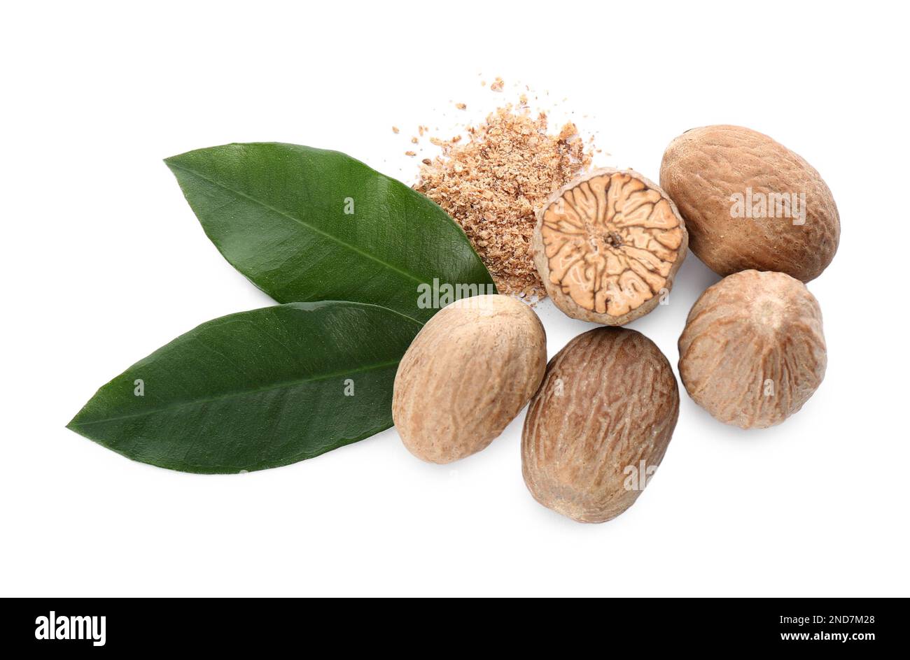Grated nutmeg and seeds with green leaves on white background Stock ...