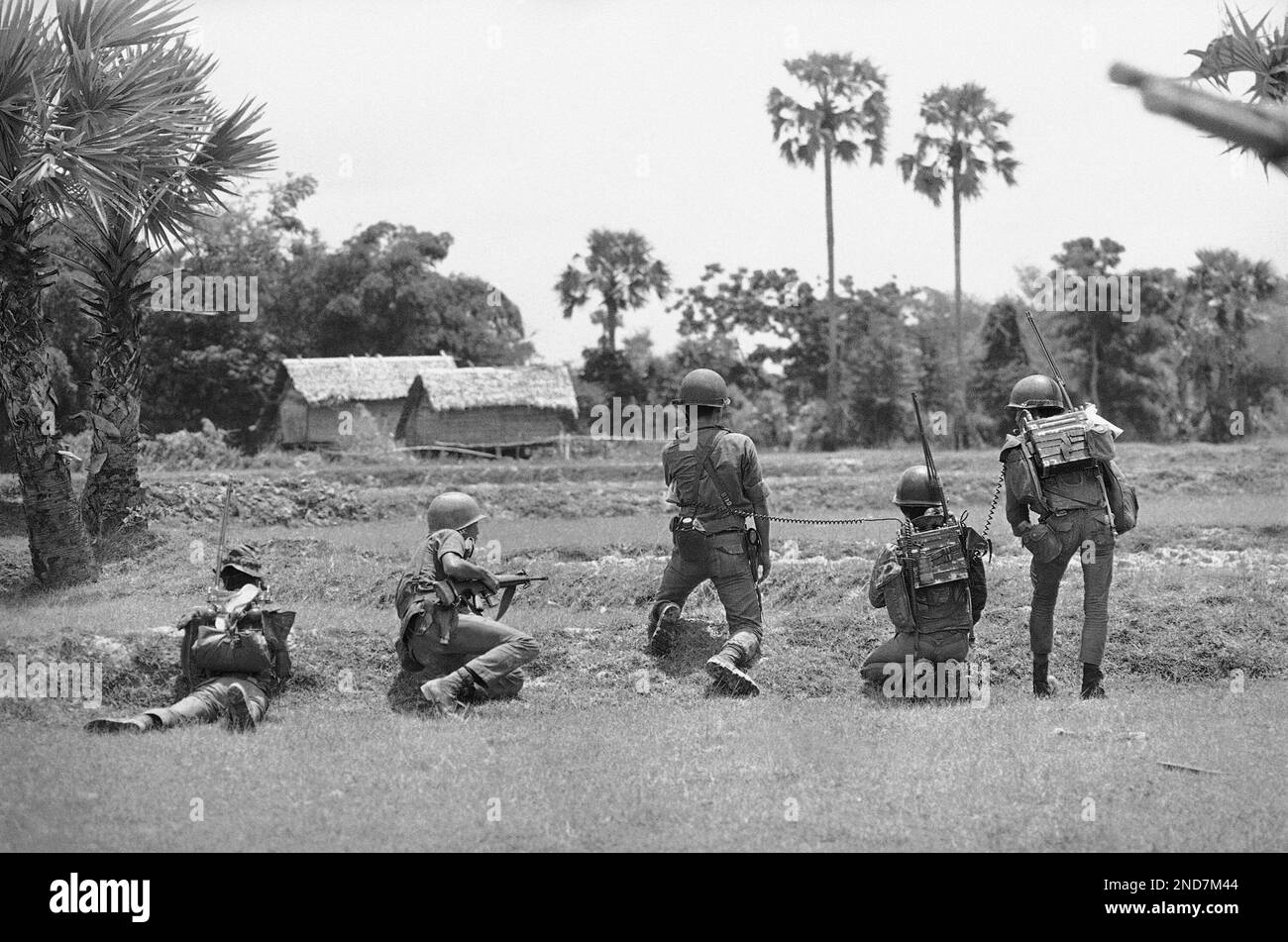 Five South Vietnamese soldiers take position along rice paddy dike near ...