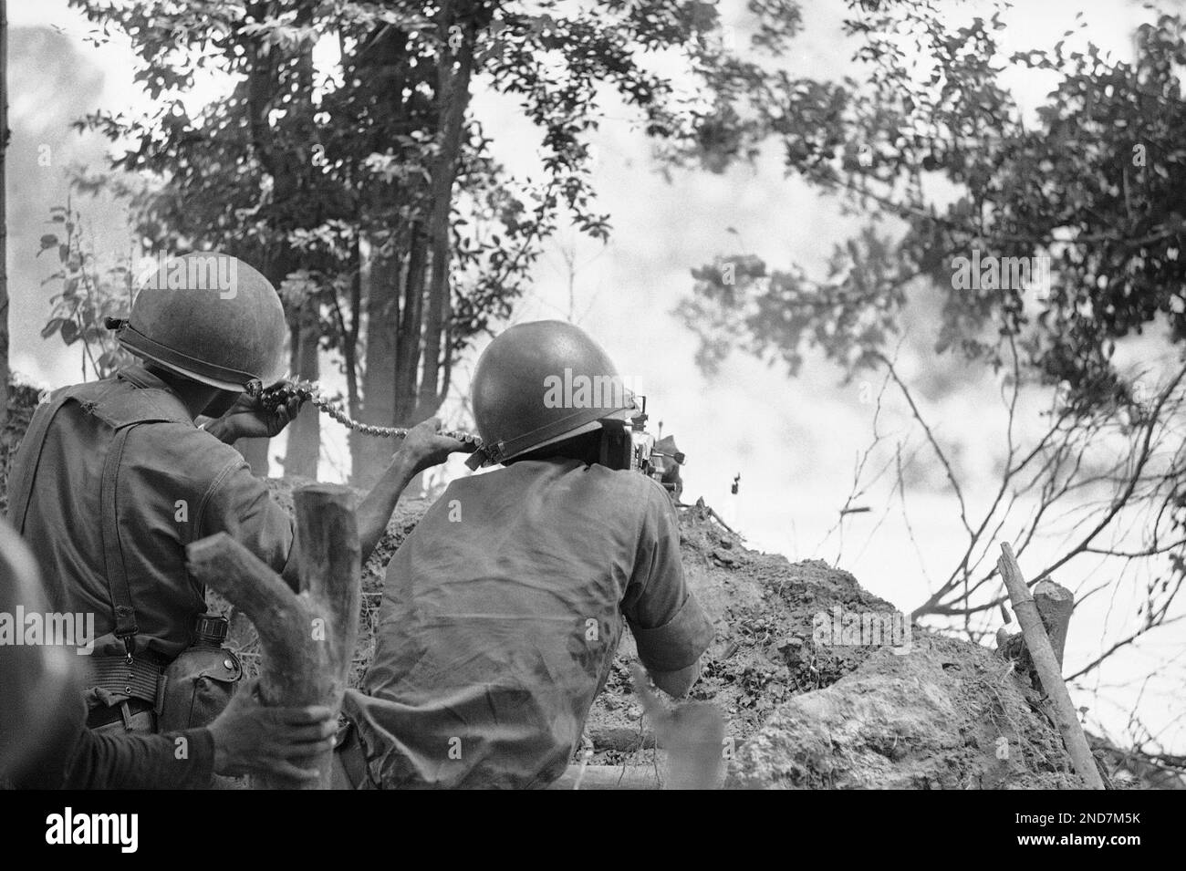 South Vietnamese machine gunner fires into suspected sniper position ...