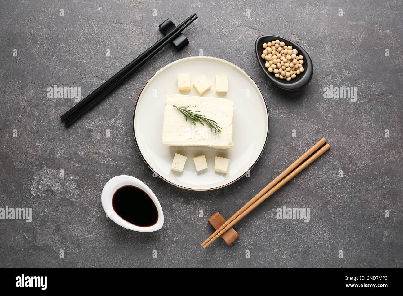 Cut tofu with soy sauce served on grey table, flat lay Stock Photo - Alamy